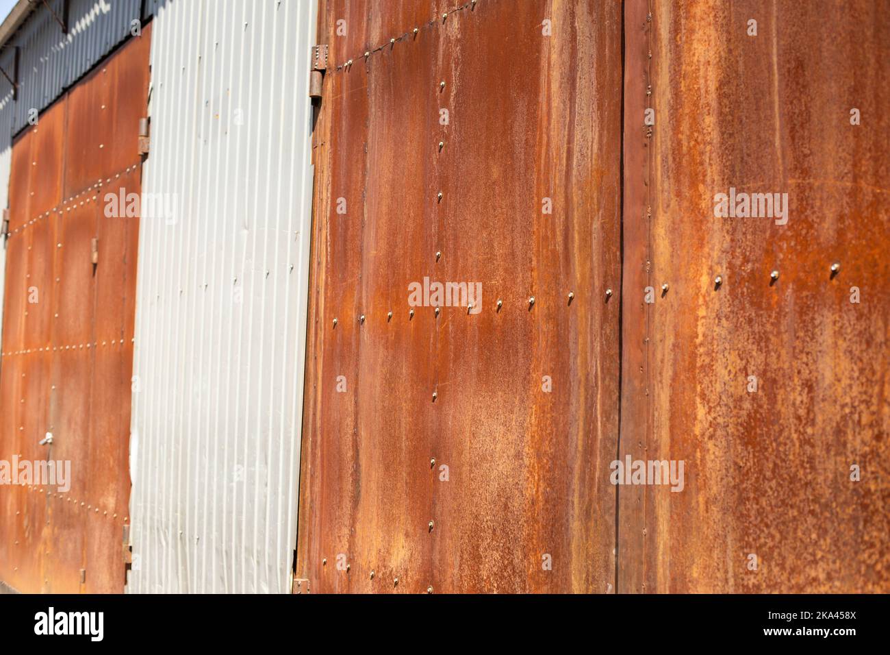 Rusty gates. More of gate to warehouse. Old wall. Entrance for freight ...