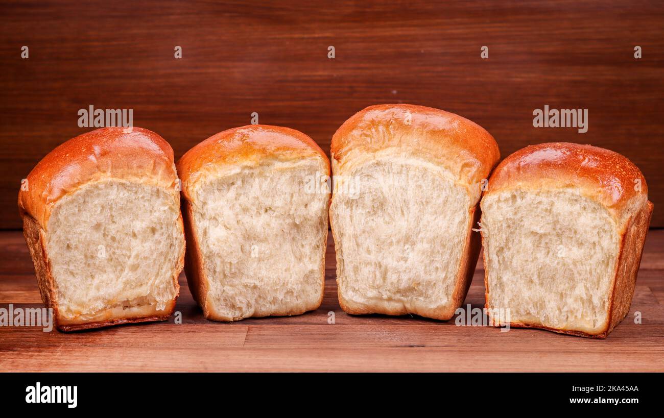 A closeup of fresh loaves of bread on the wooden surface Stock Photo ...