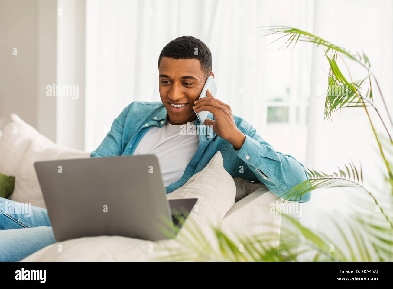 Gadget for business at home. Smiling young african american man with ...