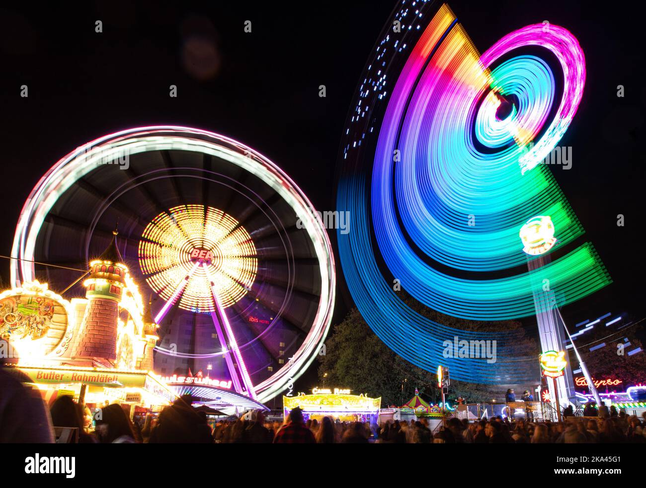 A crowd and attractions at BEA Expo in Bern, Switzerland at night Stock ...