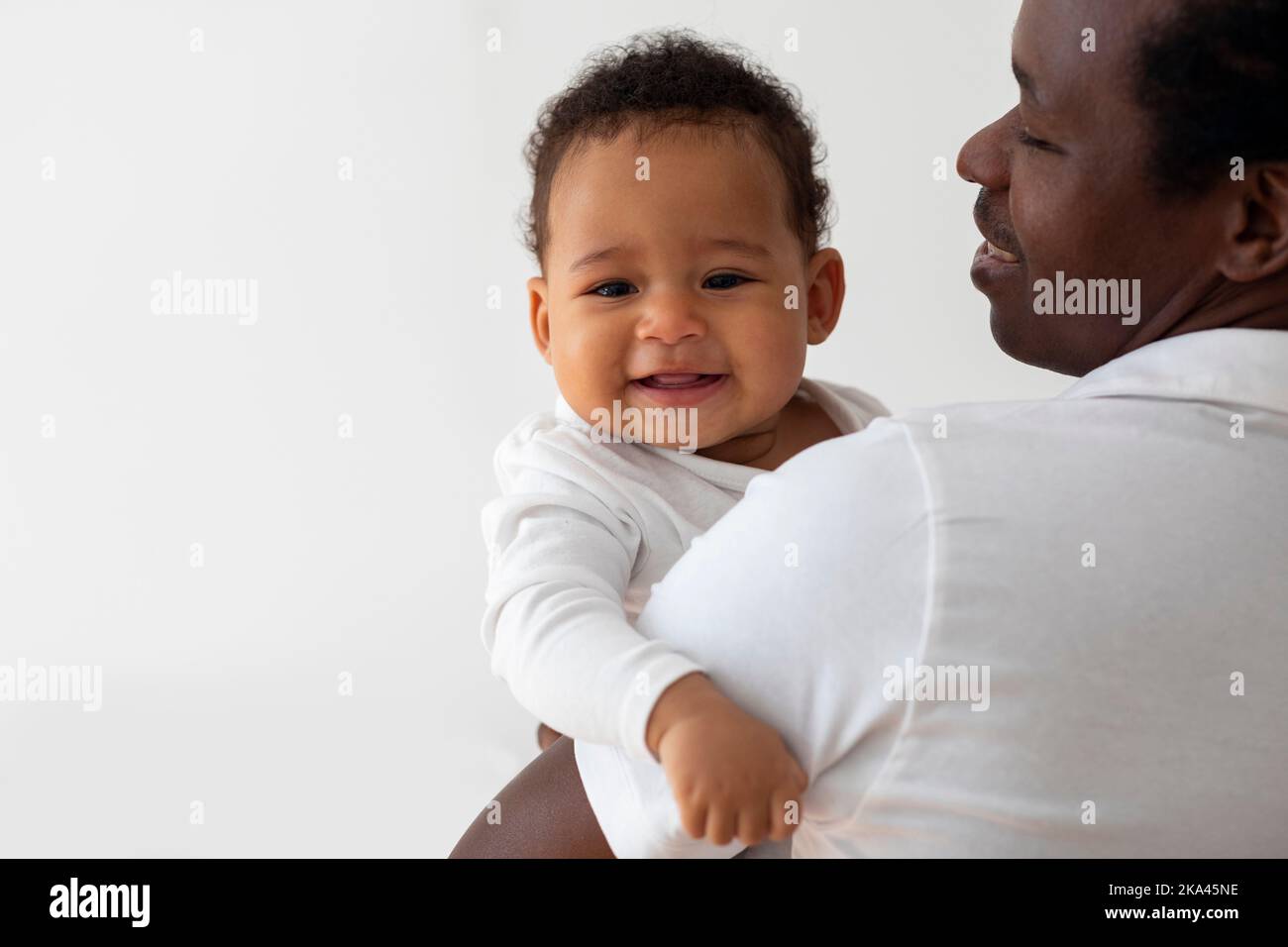Young Happy Father Holding Adorable Smiling Little Black Baby In Arms ...