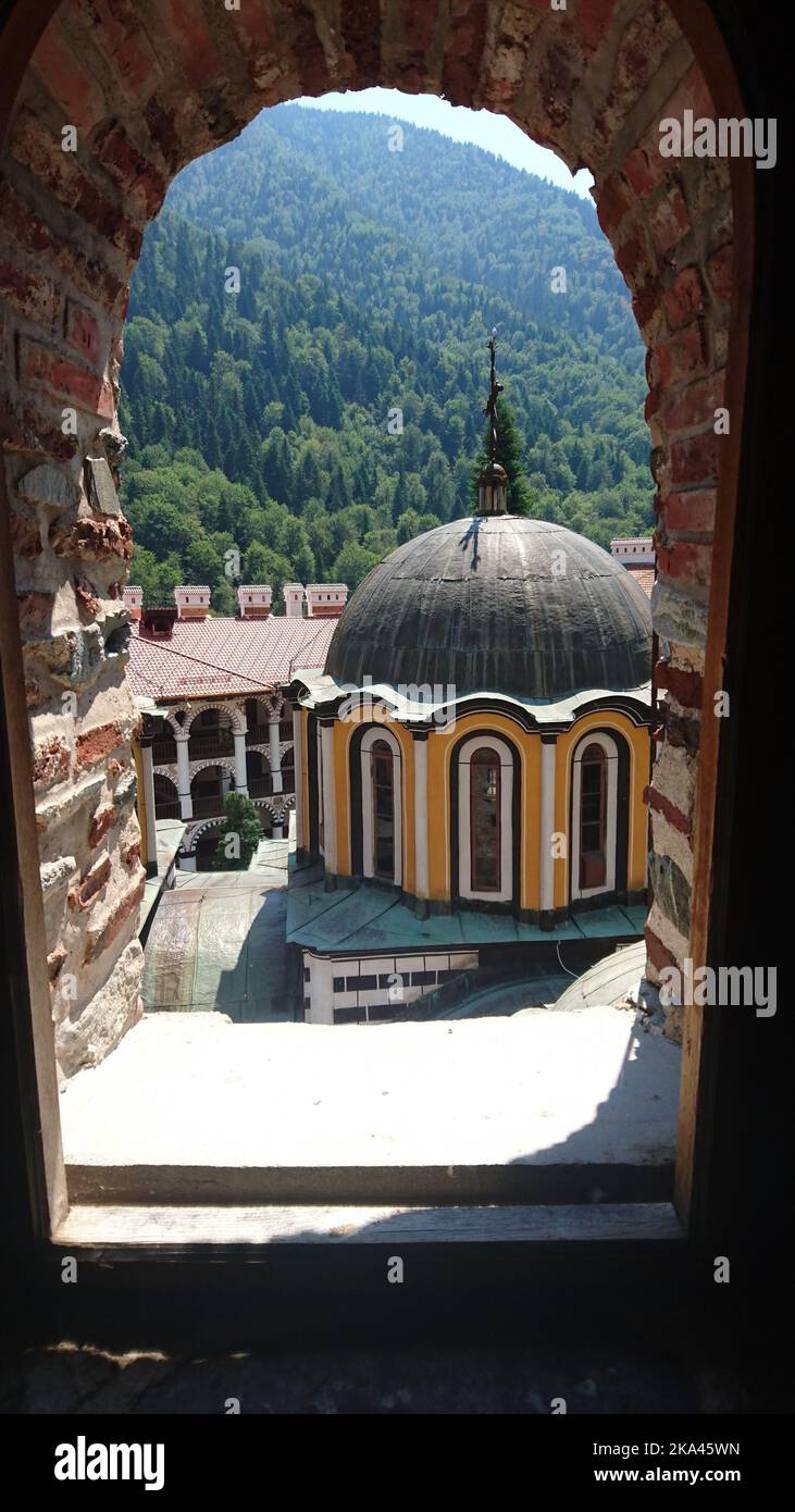 A vertical shot of Rila Monastery from an arched window Stock Photo - Alamy