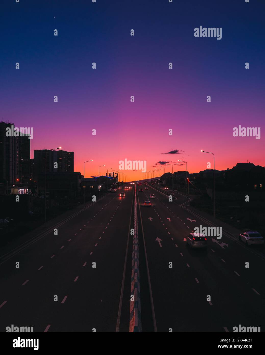 An aerial view of a highway illuminated by dim streetlights on a ...