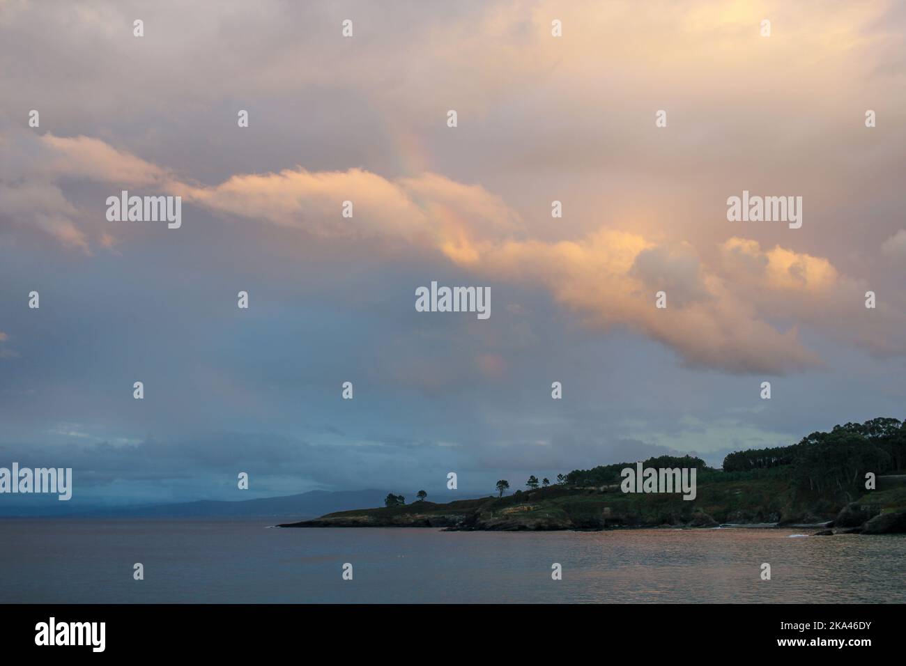 sunset lights and rainbow lights in a cloudy sky over the sea Stock ...