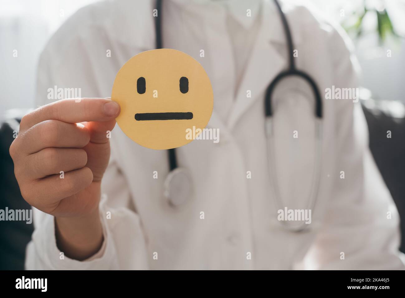 Close up of female doctor in white coat with stethoscope holding small ...