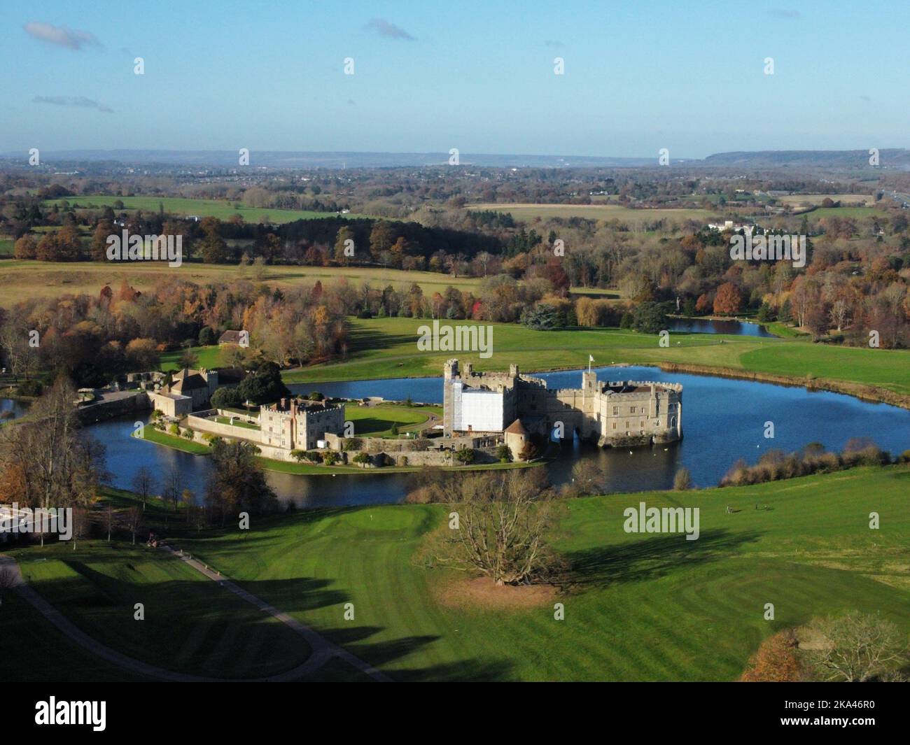 The bird's eye view of the Leeds Castle on the lake surrounded by green ...
