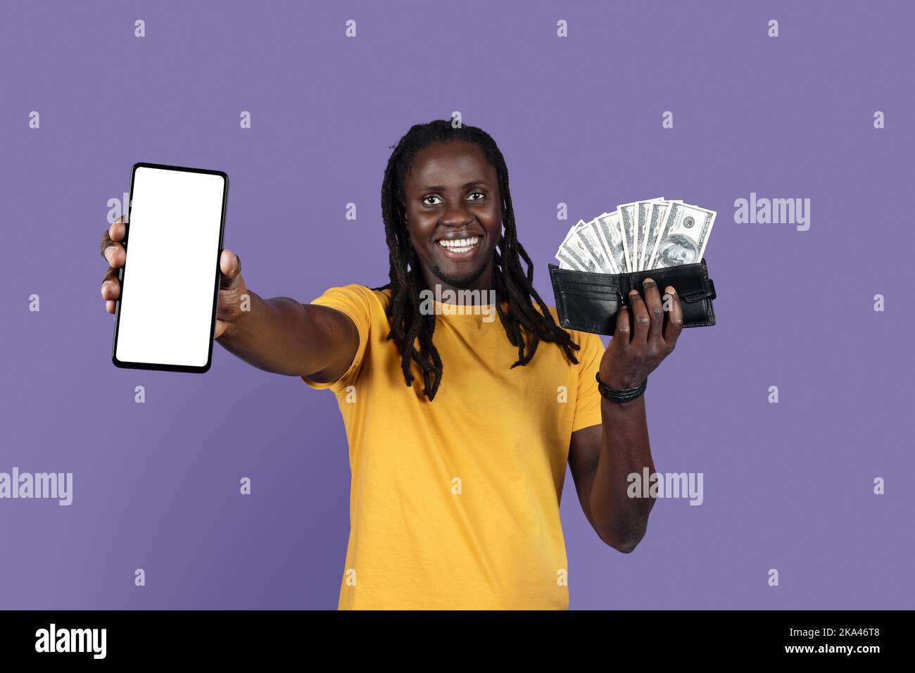 Happy wealthy black guy showing smartphone blank screen and wallet ...