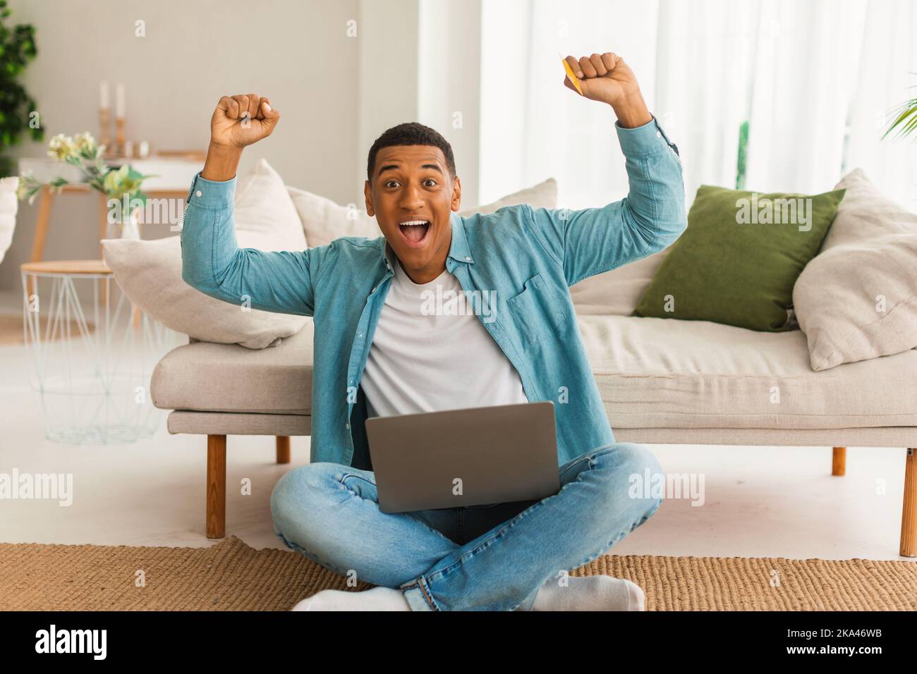 Satisfied excited millennial african american man with open mouth ...