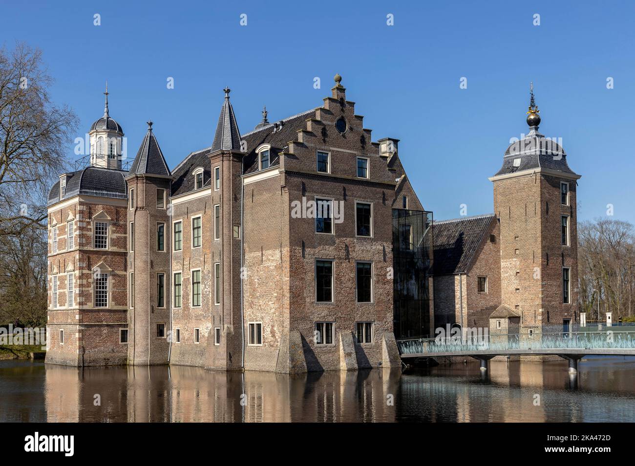 Brightly lit brick exterior facade of the Ruurlo castle with the glass ...