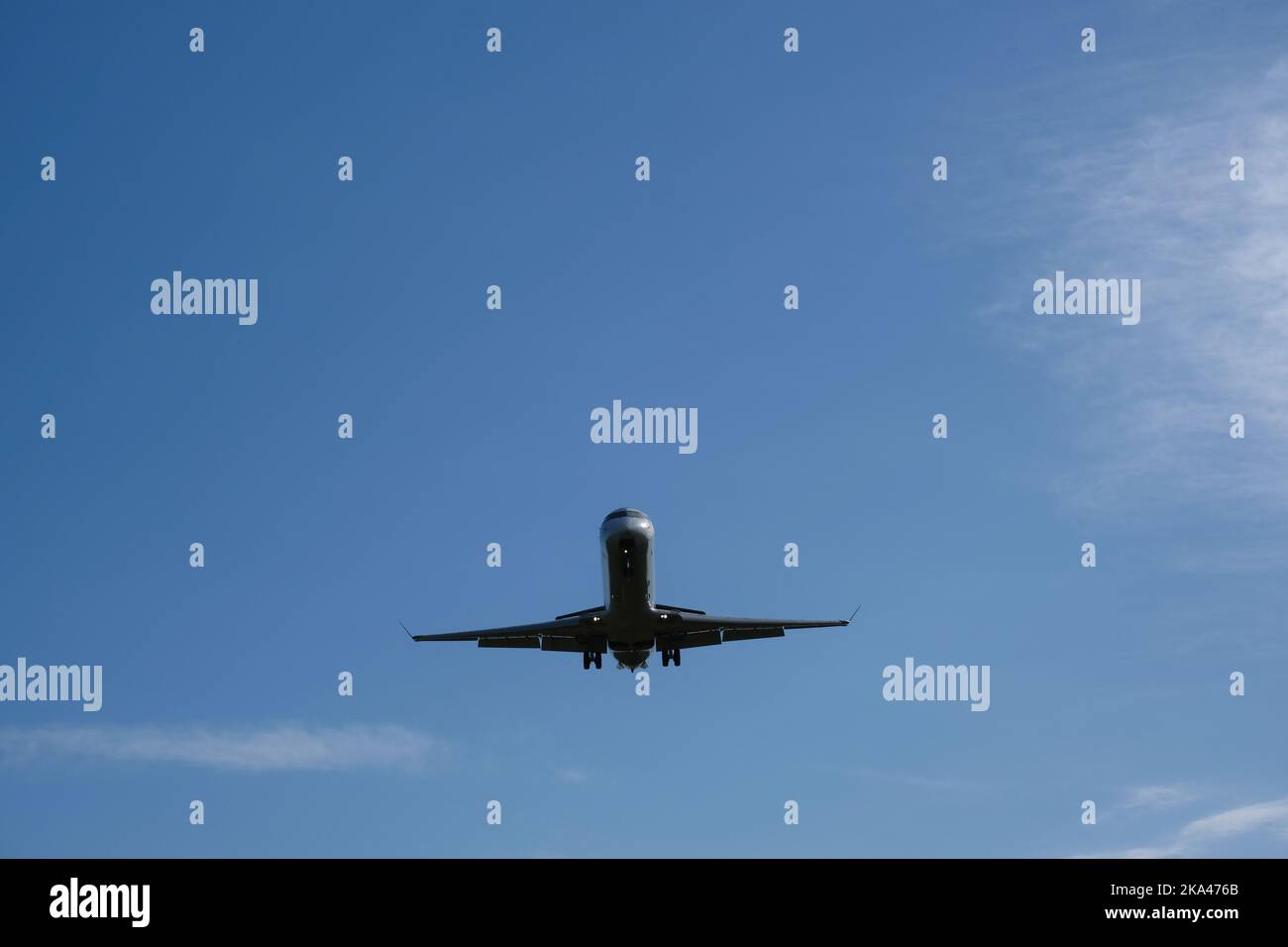 airplane on approach for landing, blue sky Stock Photo - Alamy
