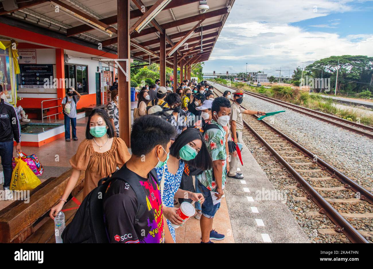 People wait at a platform in Pattaya for the incoming train bound for ...