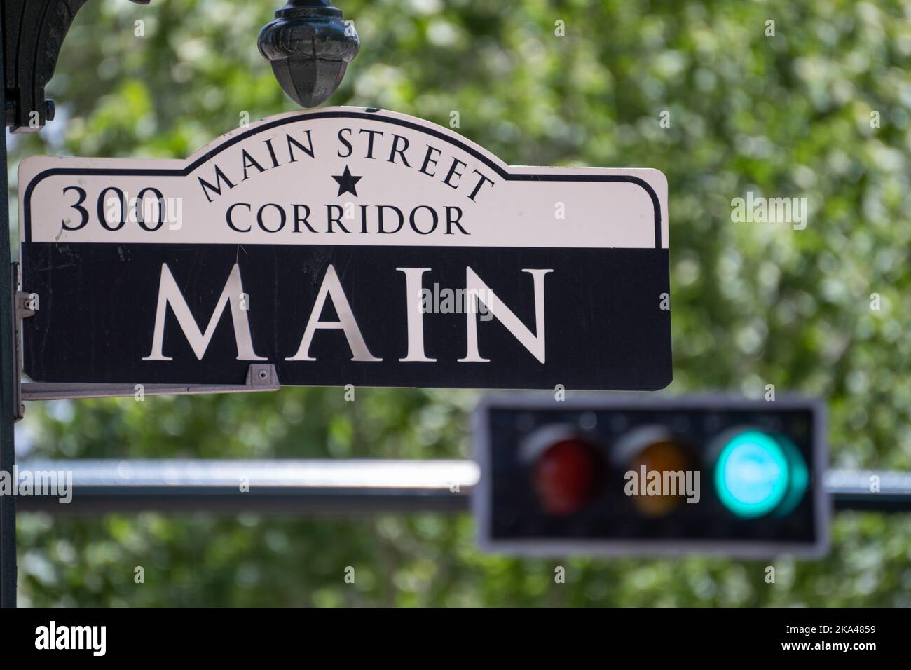 A "Main" street sign in Downtown Houston, Texas in a blurred background ...