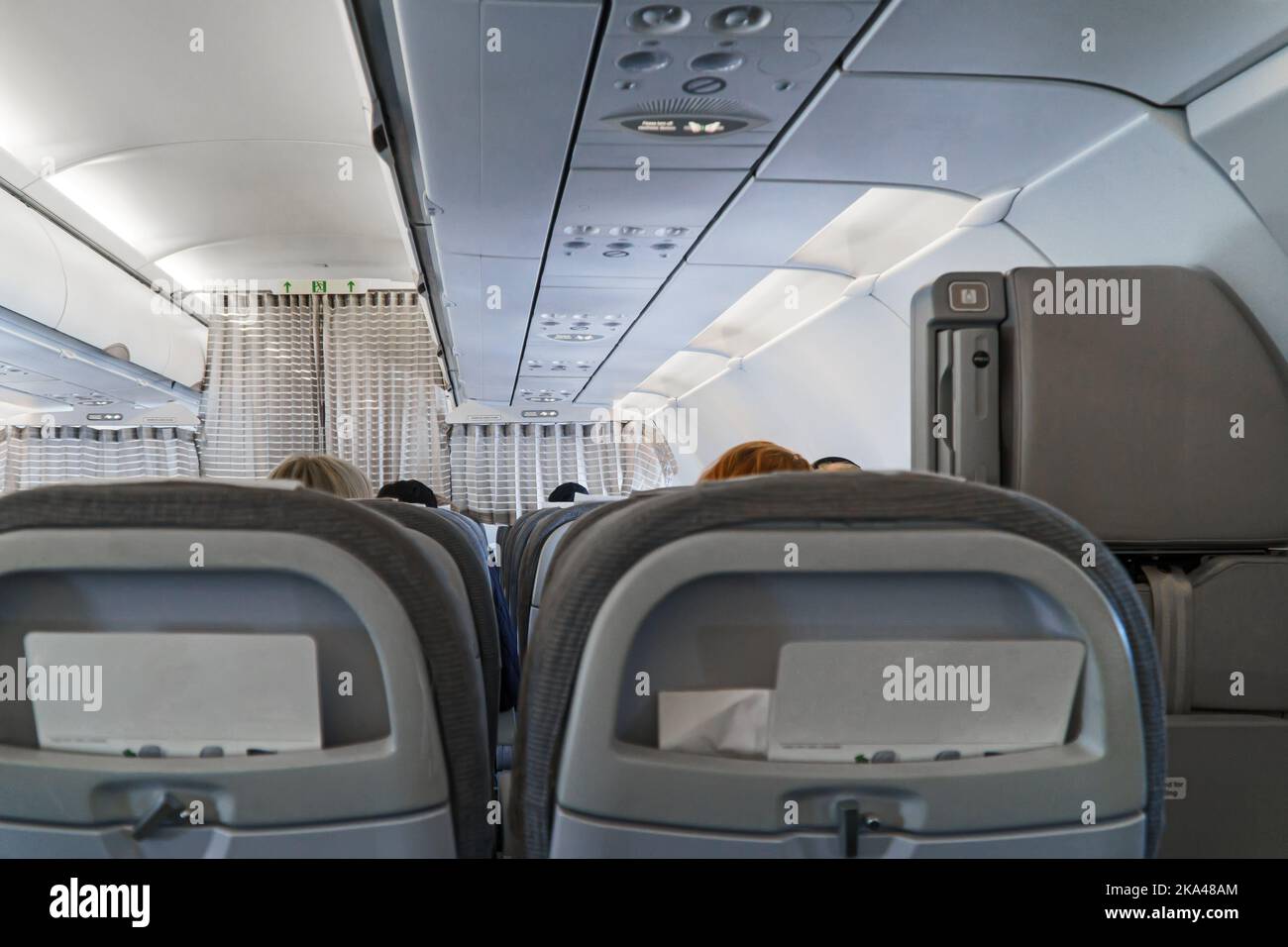 Interior inside of the plane with passengers Stock Photo - Alamy