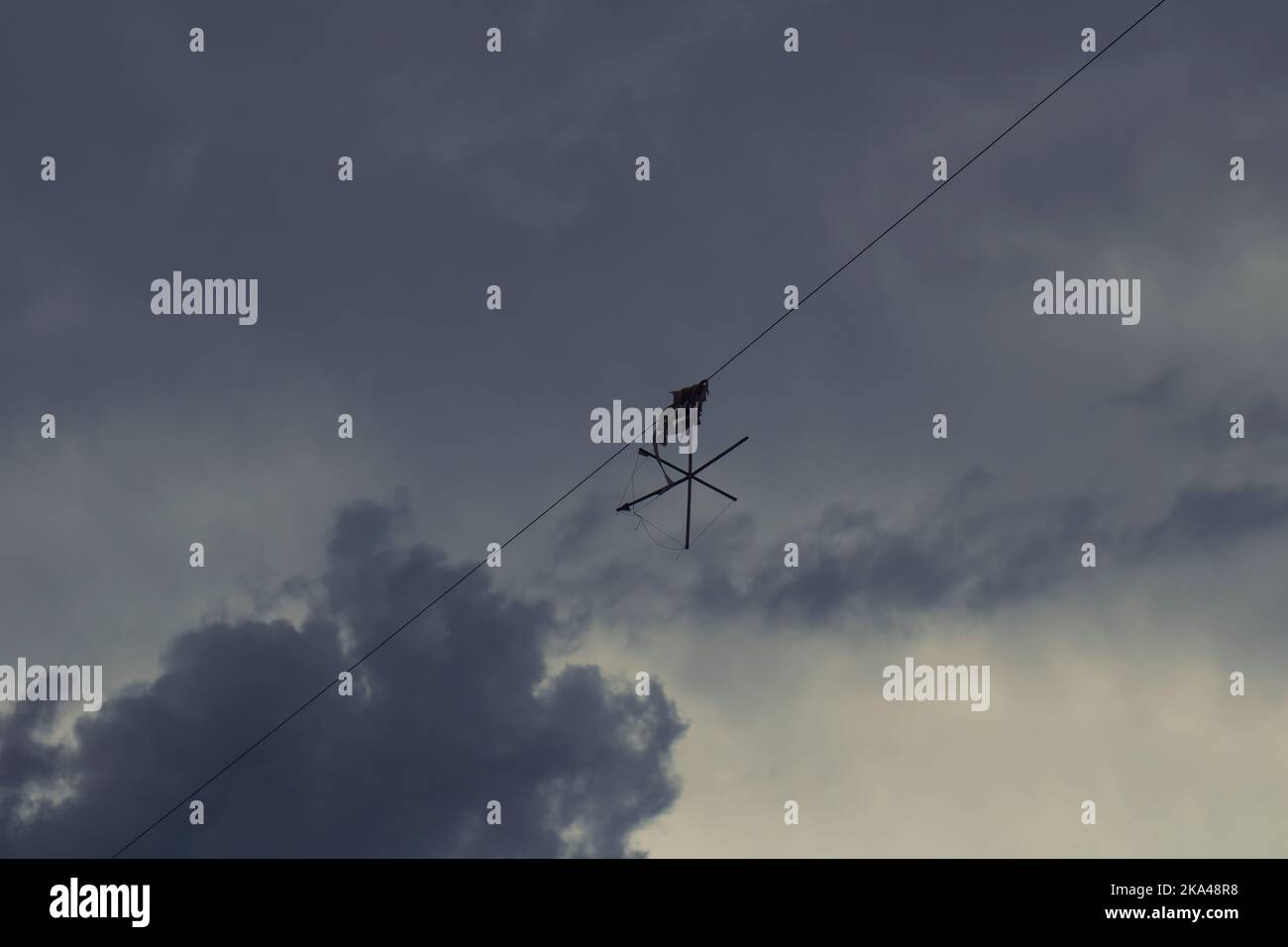 A old kite tangled in power lines Stock Photo - Alamy