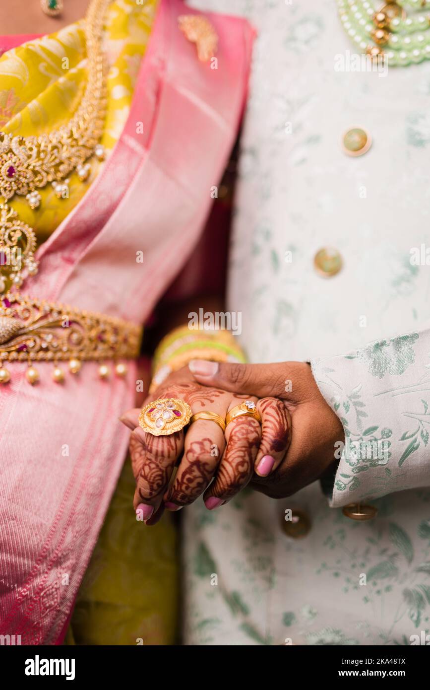 Traditional Indian bride and groom holding hands Stock Photo - Alamy