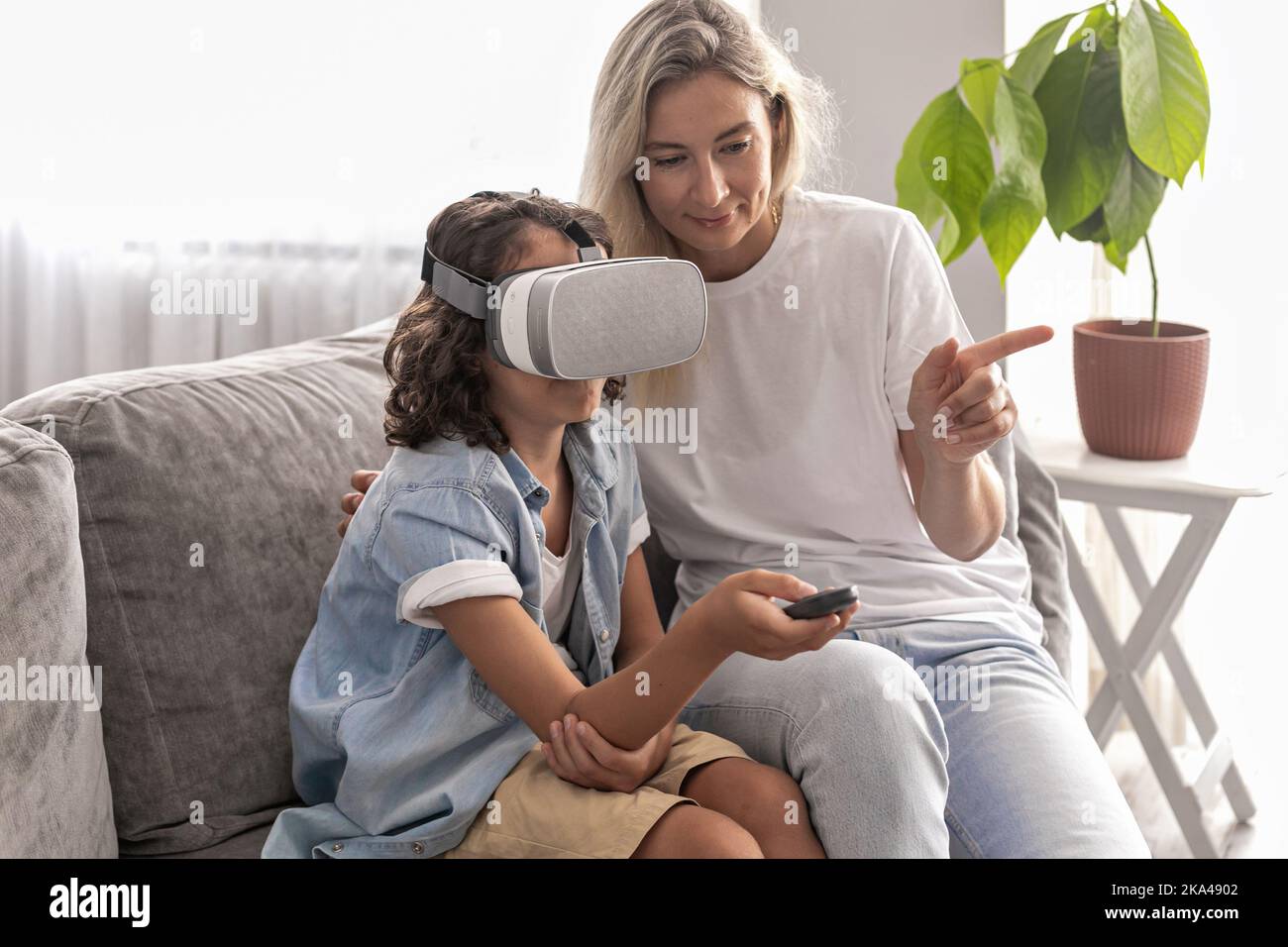 boy kid wearing virtual reality headset with his mother vr glasses in ...