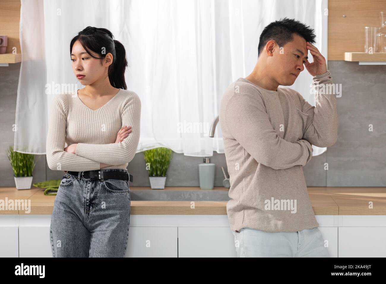 Sad japanese husband and wife experiencing difficulties in marriage ...
