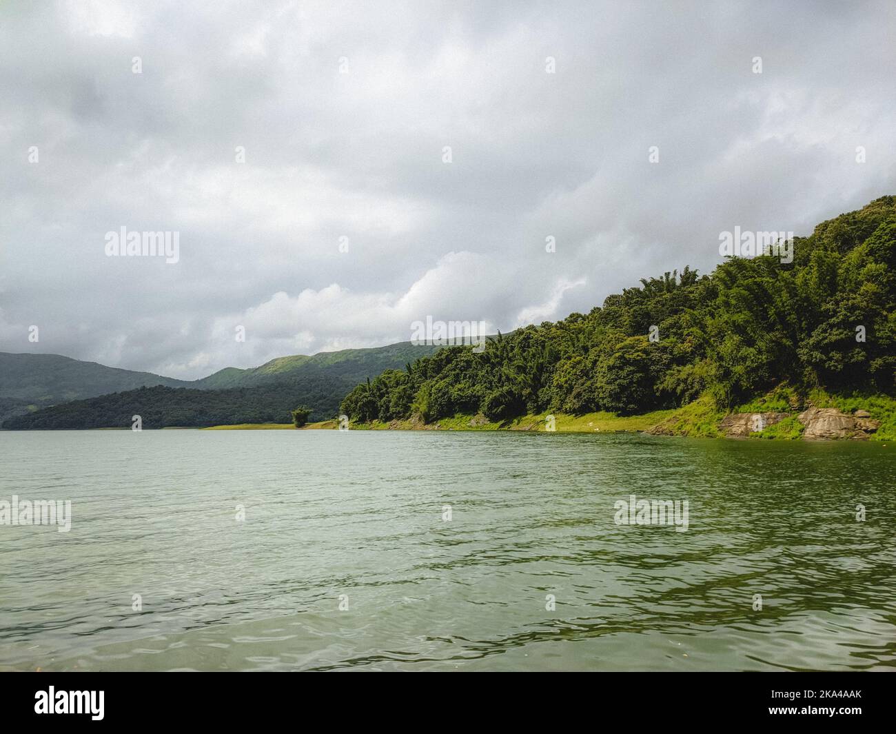 Green water in a moody day. The water body is a reservoir. Dark monsoon ...