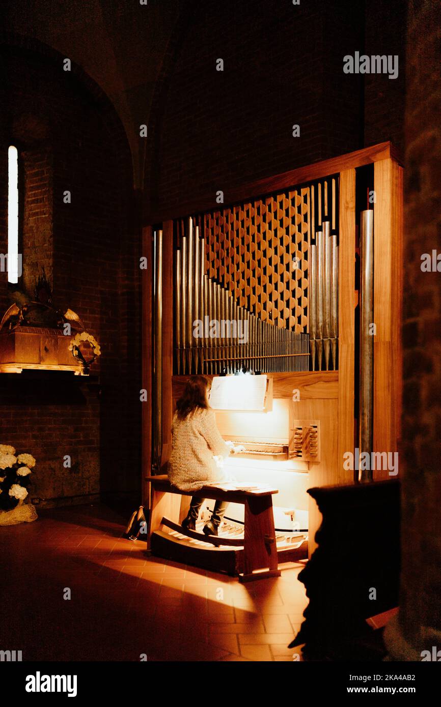 A woman playing music on a huge Pipe Organ under sunlight Stock Photo ...