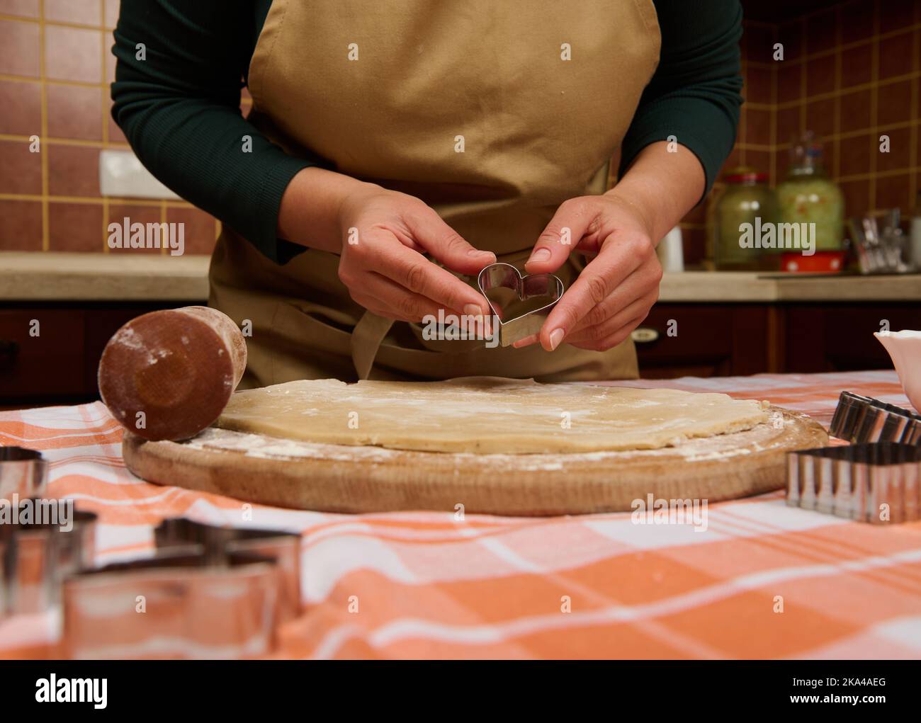 Details: hands of woman chef confectioner, baker holding a heart shaped ...
