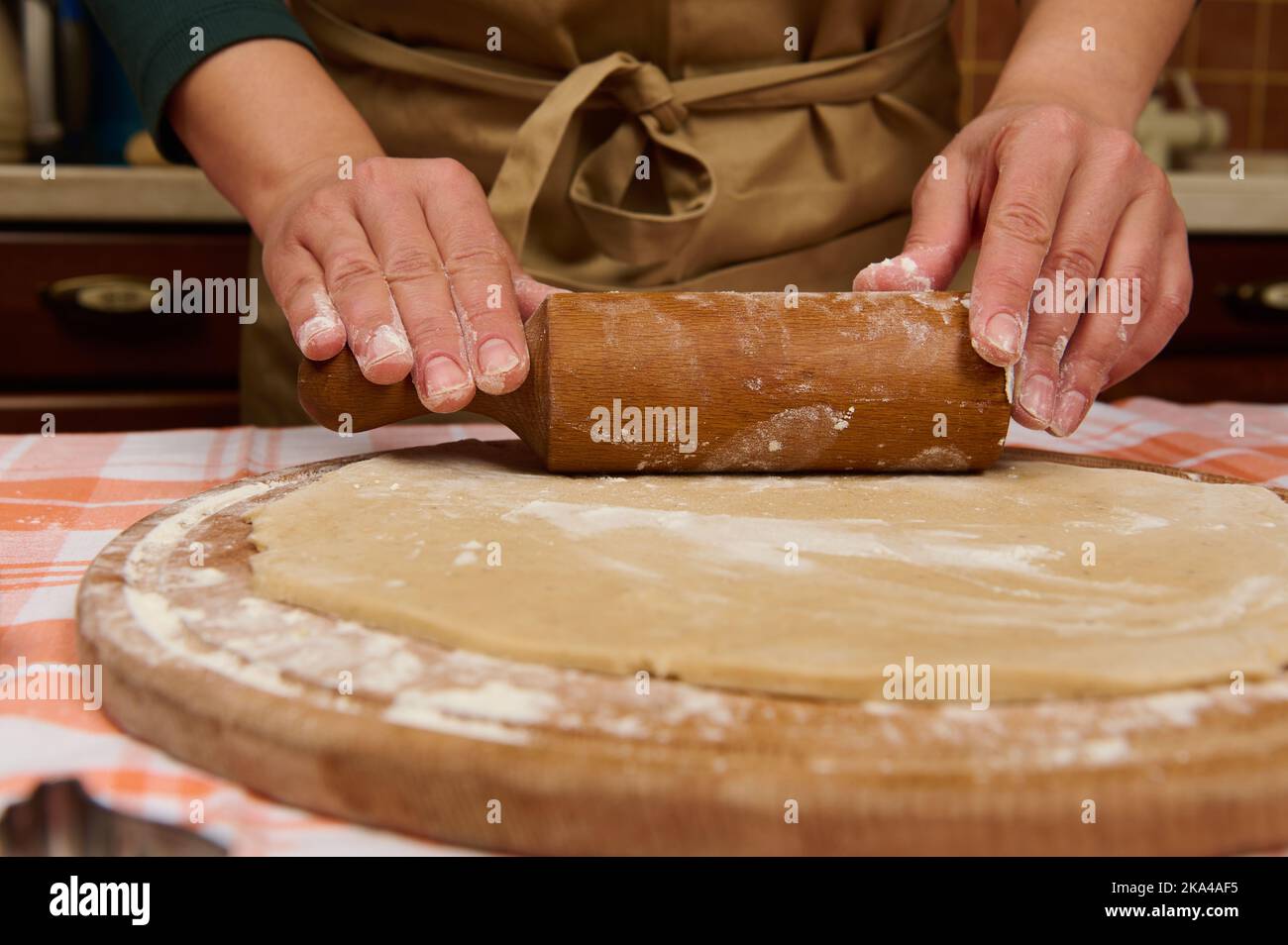 Details: chef confectioners hands using rolling pin, roll out the dough ...