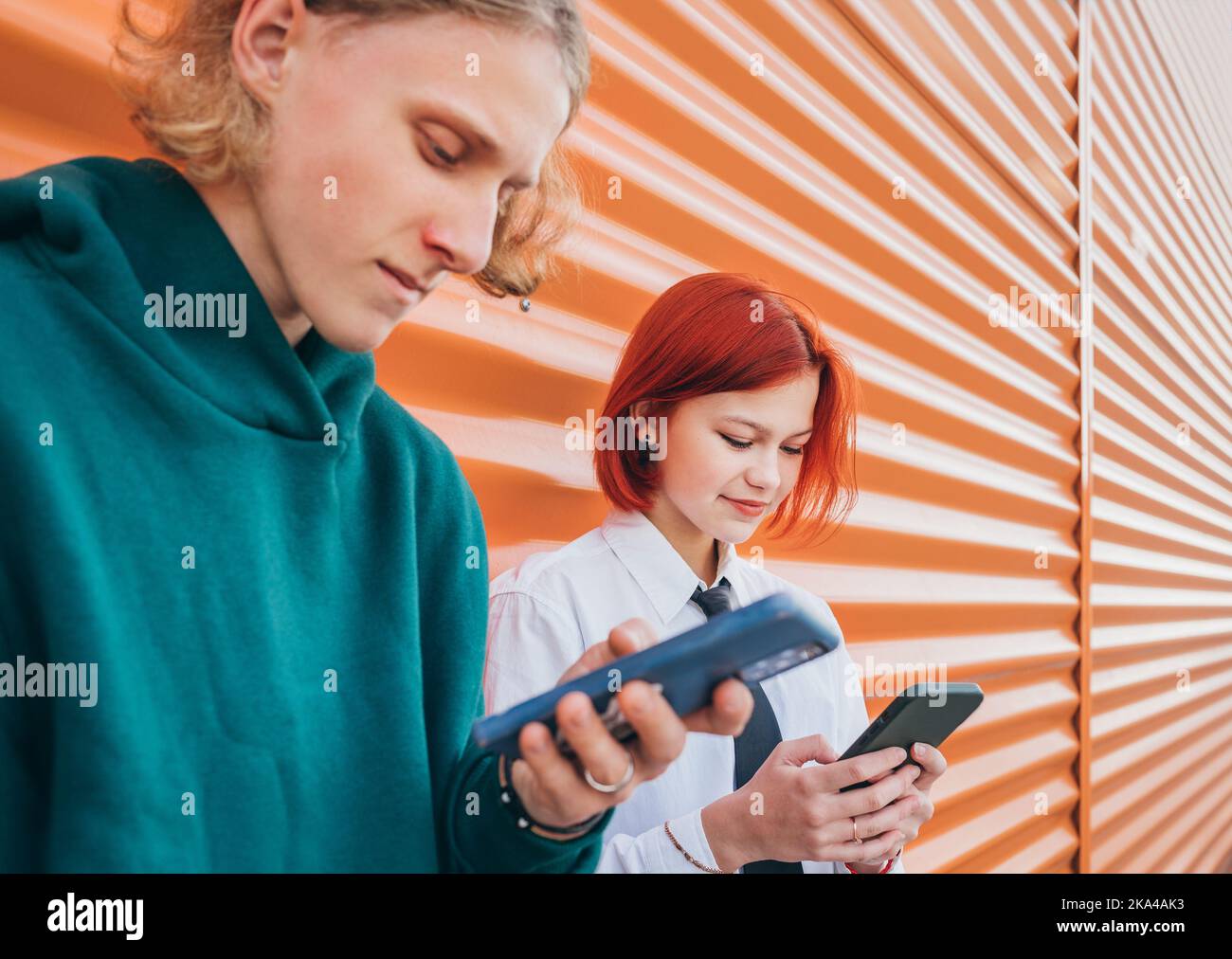 Young caucasian teens girl and boy portrait. Teenagers browsing ...