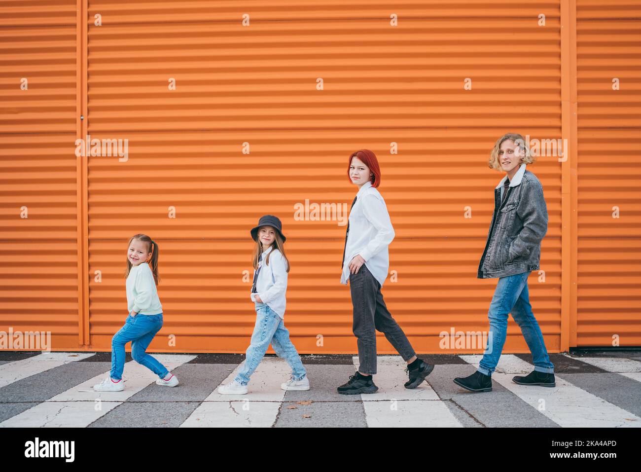Fashion-dressed quartet of small kids and teenagers sisters and ...