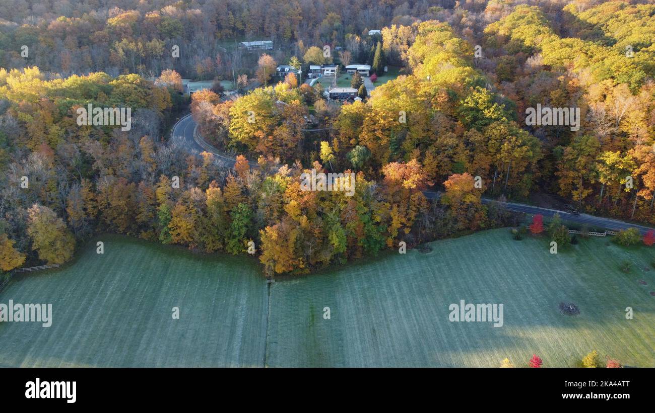 An aerial view of a small village near a forest in the countryside ...