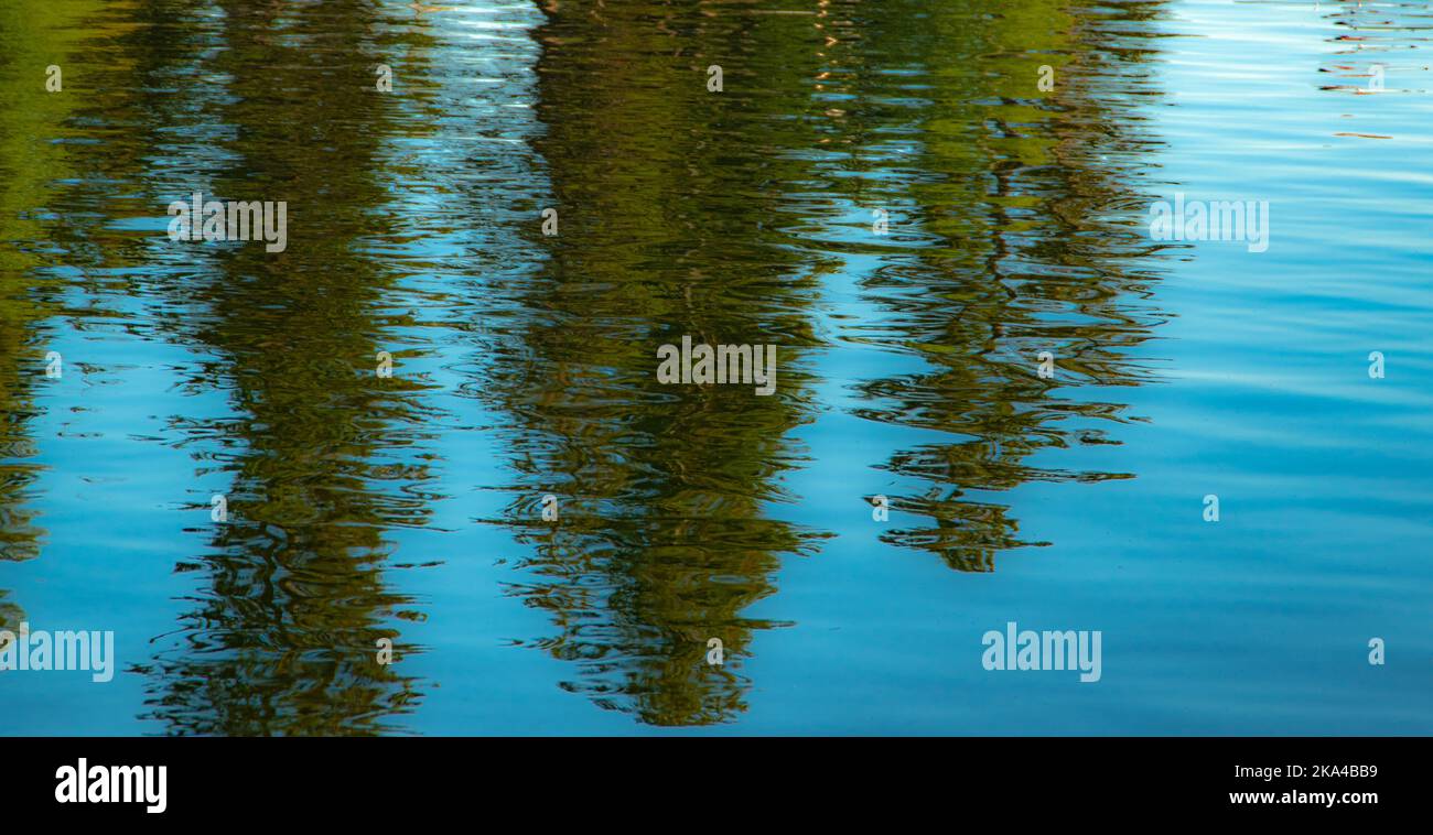 Colors and light reflected in the blue water waves Stock Photo - Alamy