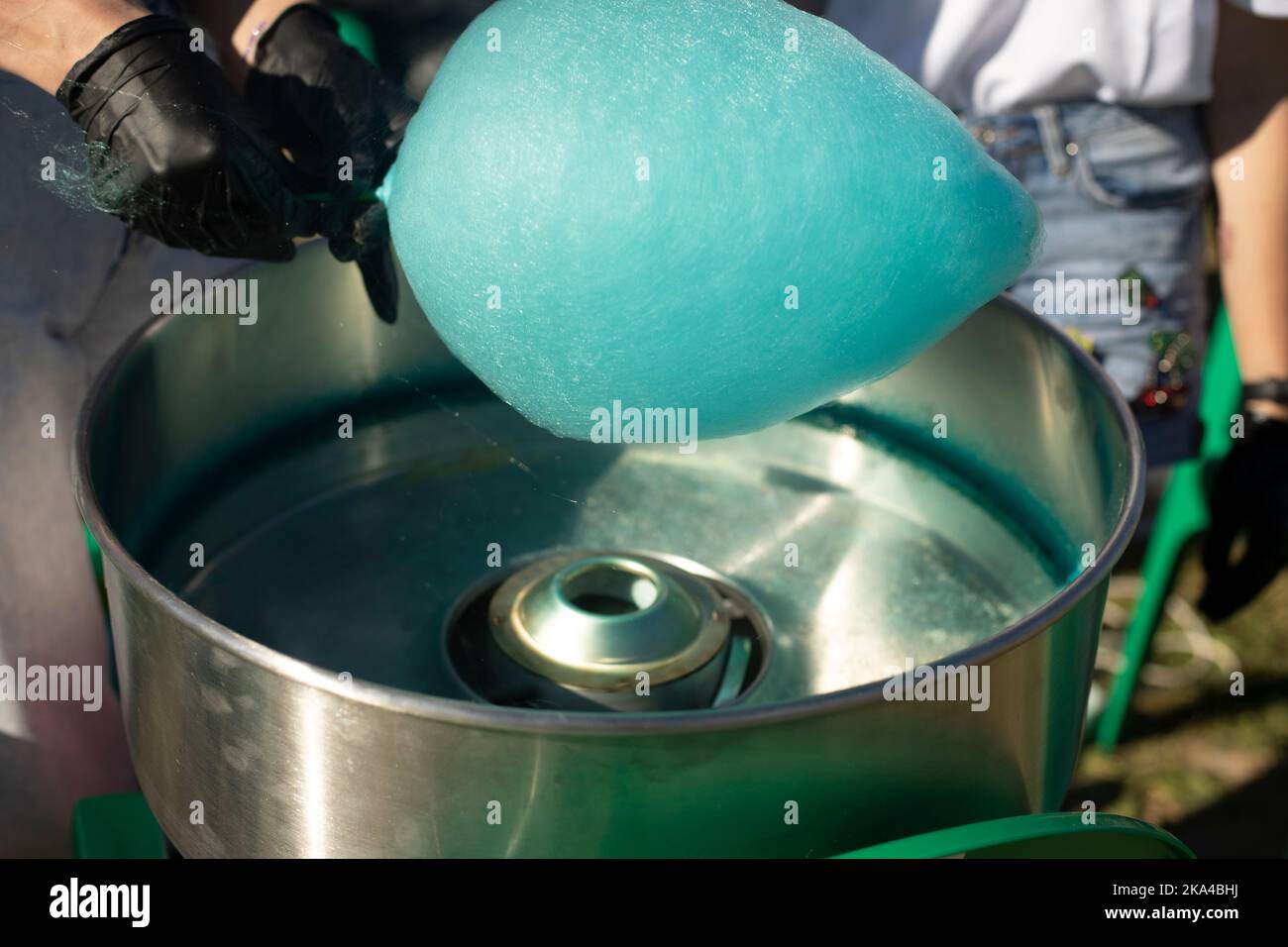 Cotton candy outside. Blue cotton candy on stick. Sugar product ...