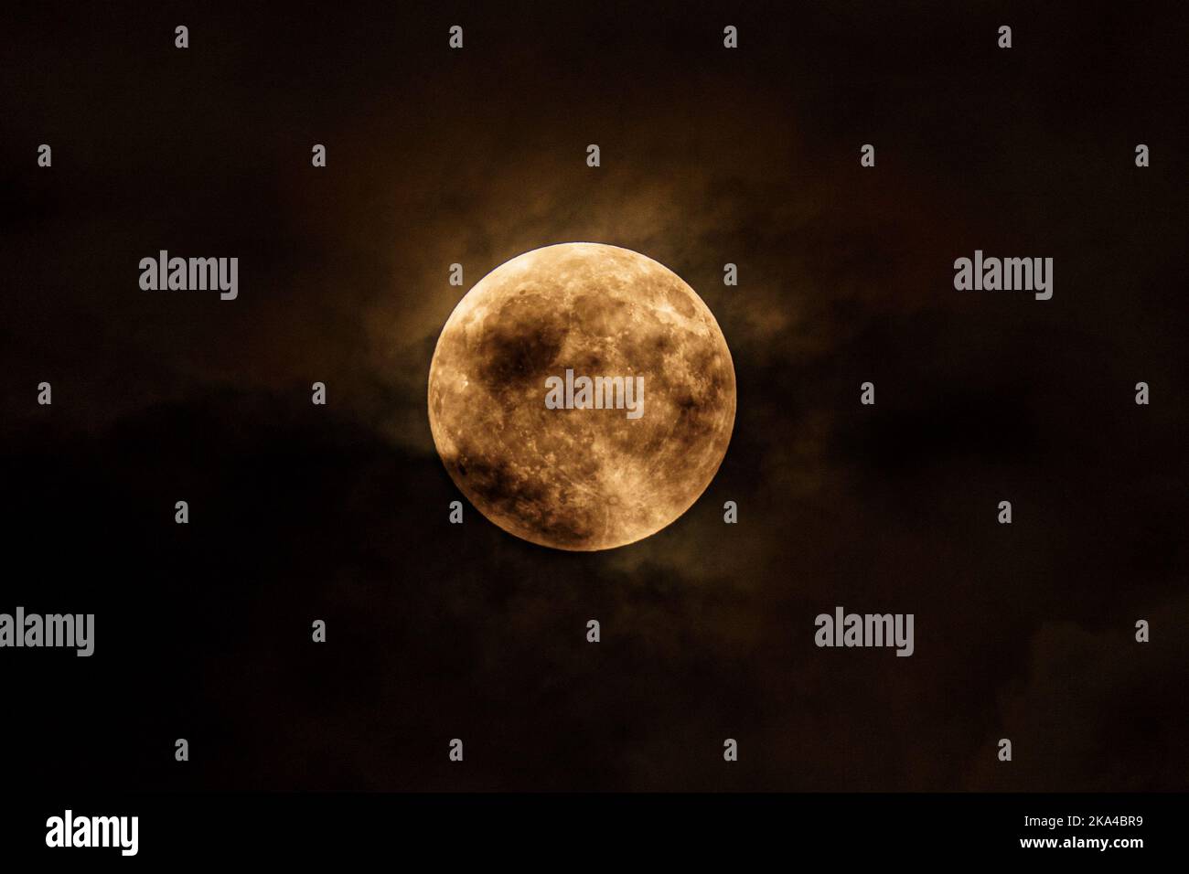 Glowing full Moon in a dark sky Stock Photo - Alamy