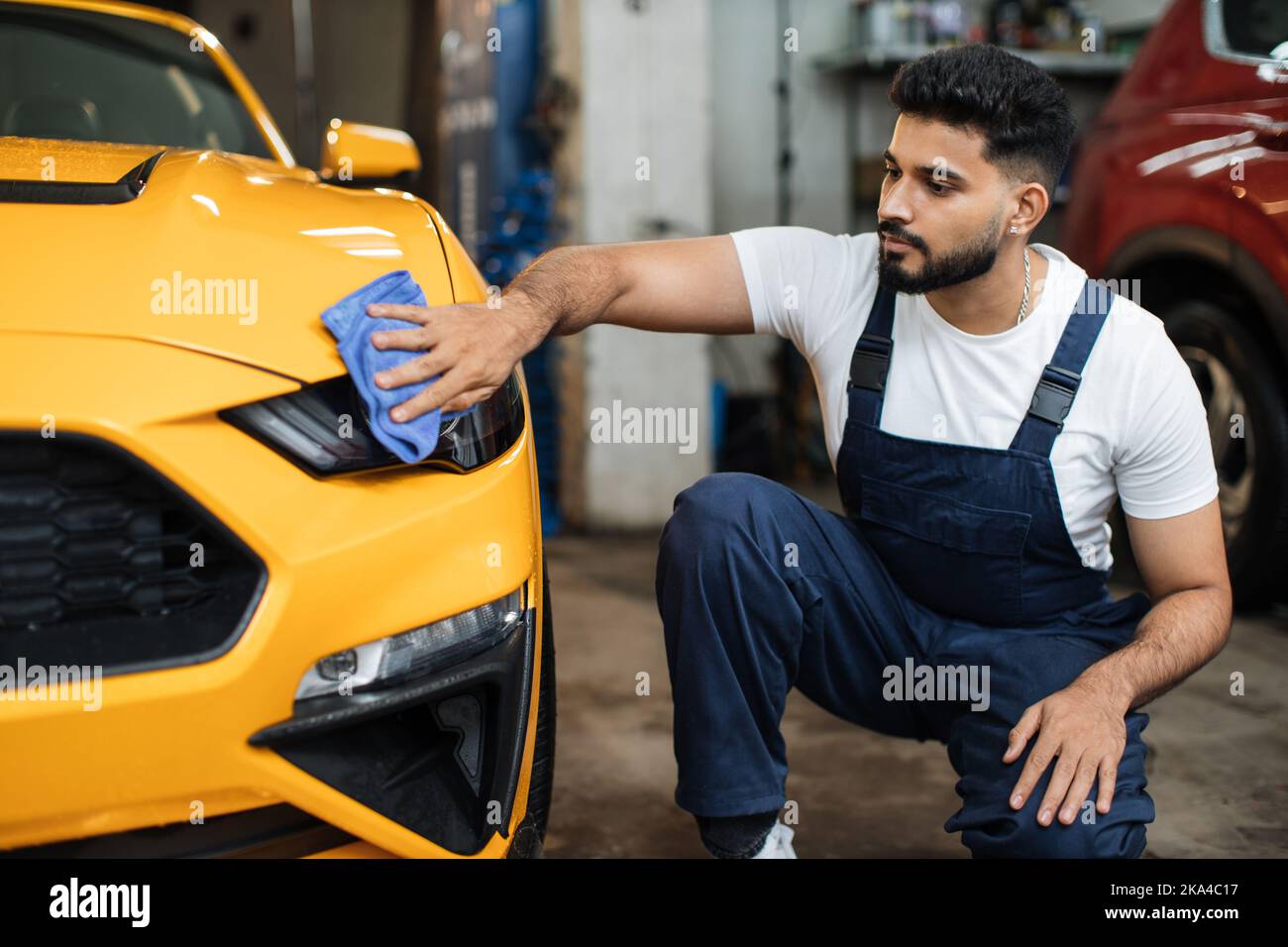 Car detailing and cleaning concept. Male car wash worker holds the ...