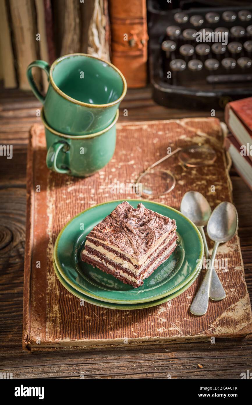 Tasty chocolate cake and coffee with books and typewriter Stock Photo ...