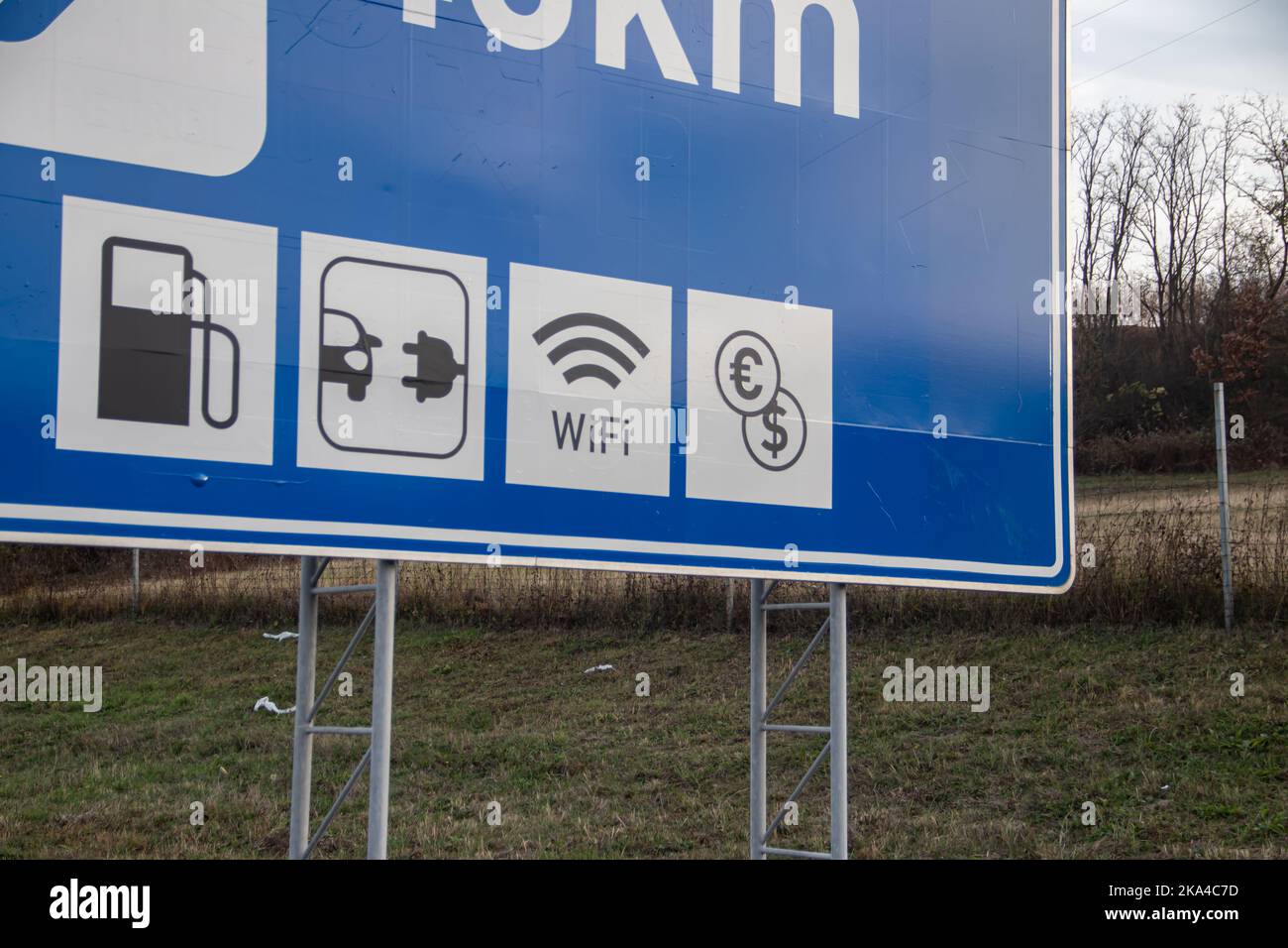 Street sign (sign board) on highway for fuel station with symbols and ...