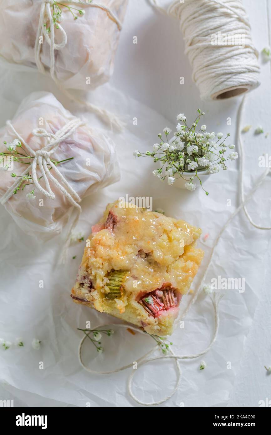 Sweet and tasty yogurt pie packed in a white paper. Pie with cream and ...