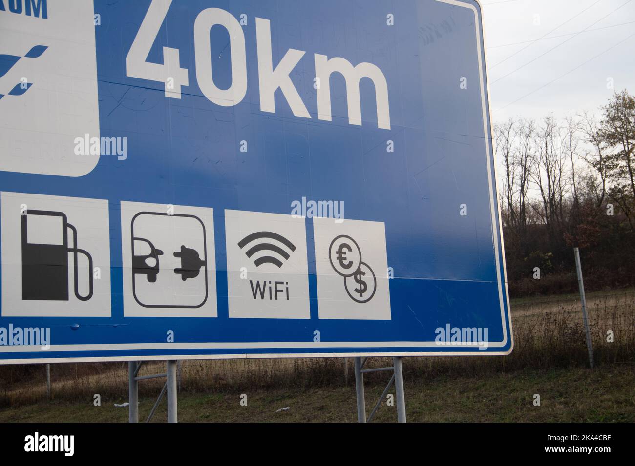 Street sign (sign board) on highway for fuel station with symbols and ...
