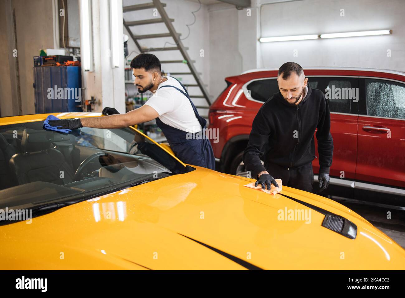 Team of car wash workers men, wearing protective clothes uniform ...
