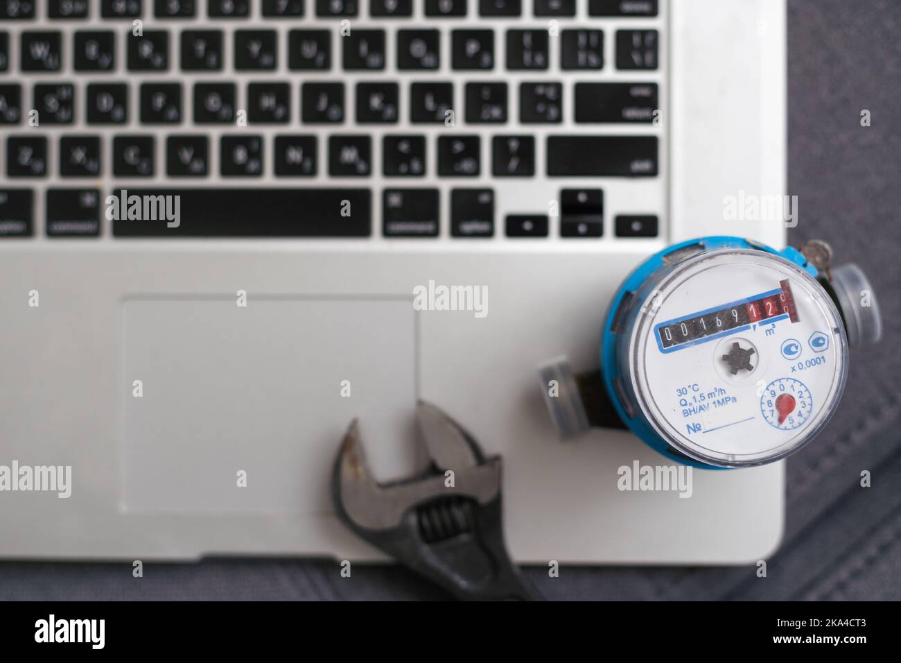 Close up shot water meter and laptop Stock Photo - Alamy
