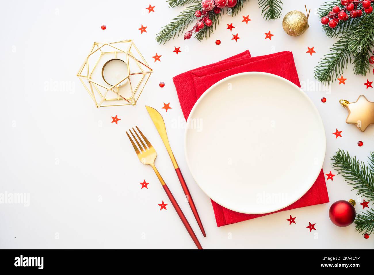 Christmas table setting with white plate and christmas decorations on ...