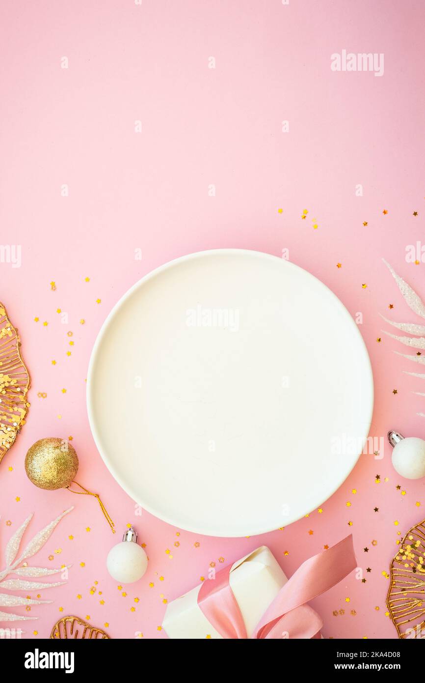Christmas table setting with white plate and christmas golden ...