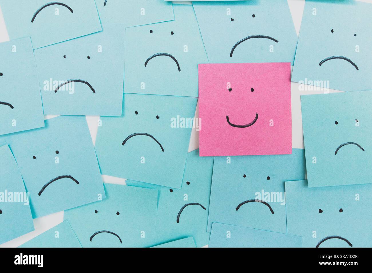 Happy Concept. Background of spicy notes. Pink sticky note is among ...