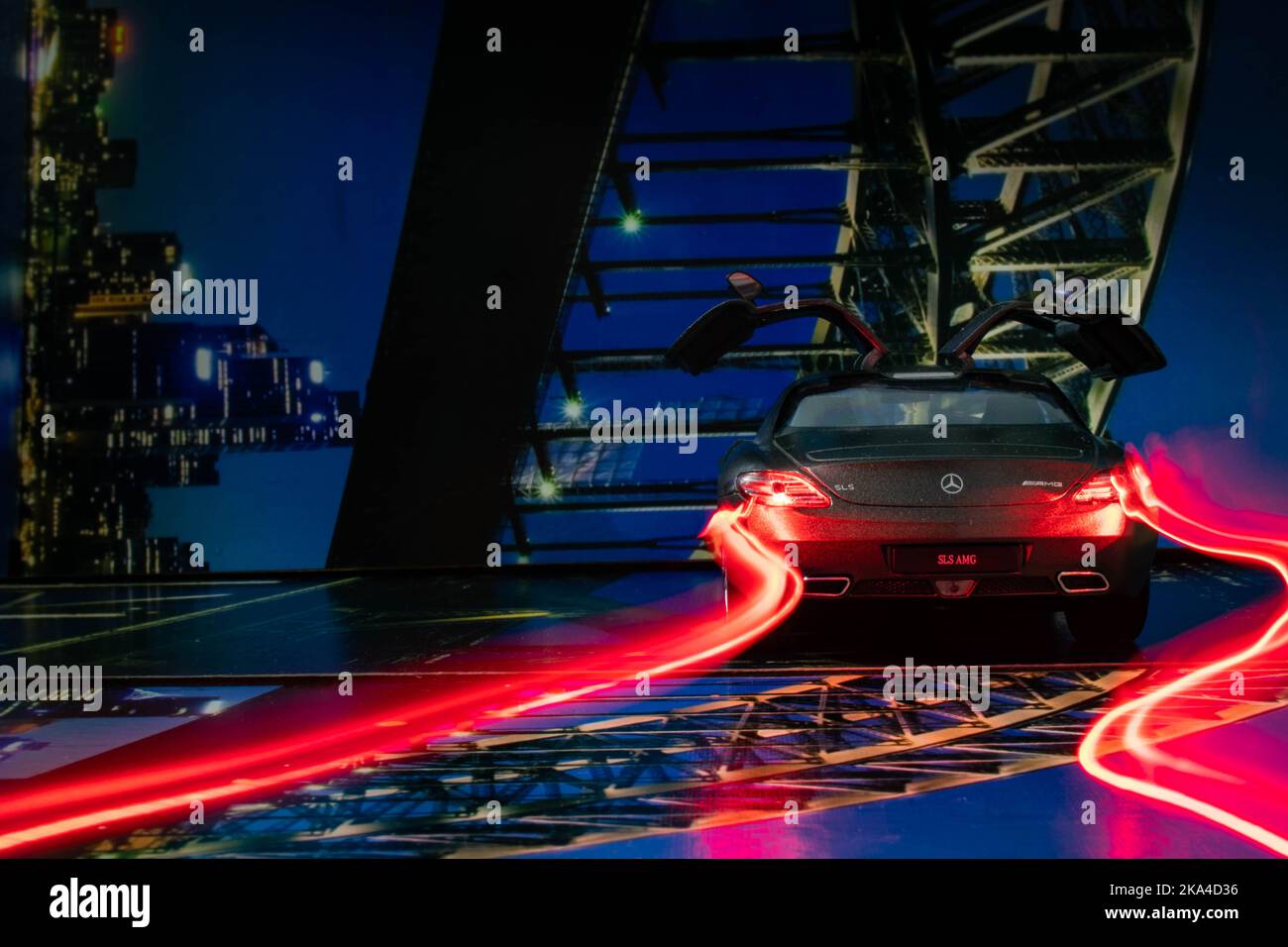 A back view of black Mercedes Benz SLS AMG with red neon light traces ...