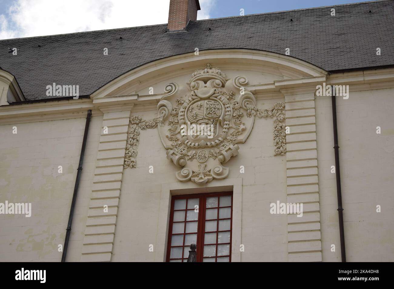 The facade of nan old building with carved walls and a grey roof Stock ...