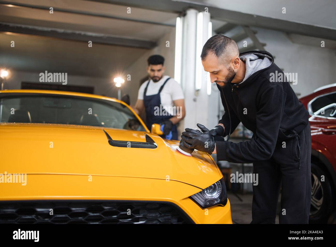 Team of young bearded men, workers of auto detailing service. Males ...