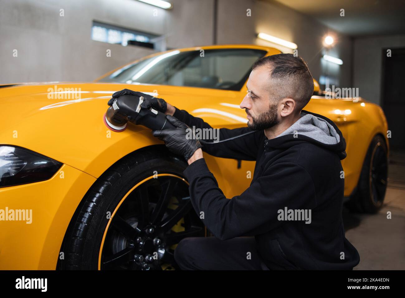 Car detailing and polishing concept. Professional Caucasian male car ...