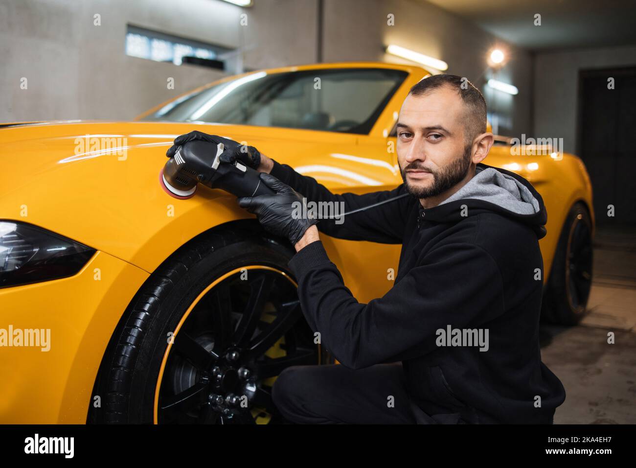 Car detailing and polishing concept. Professional Caucasian male car ...