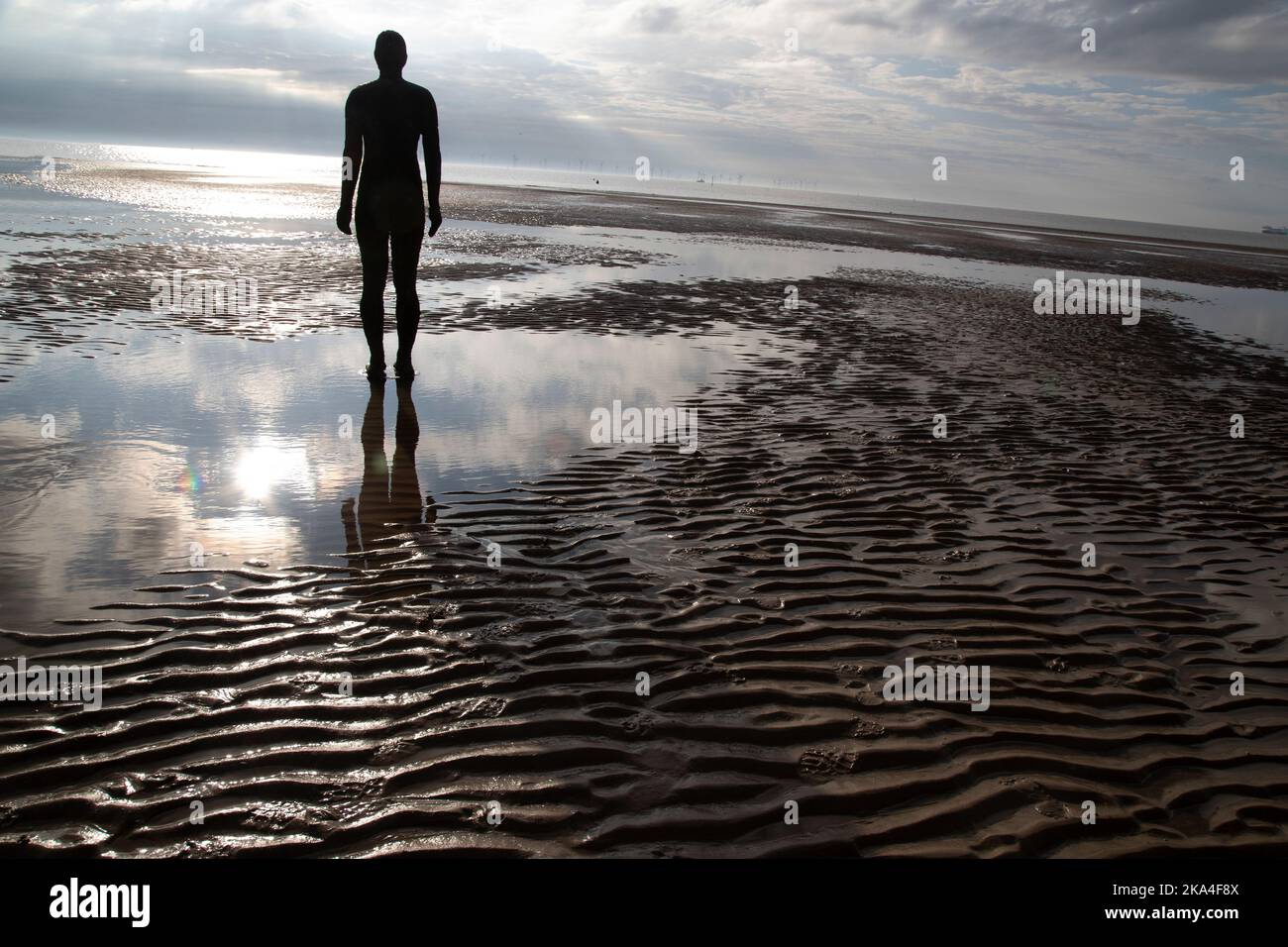 One of Antony Gormley's cast iron sculpture figures of a man looking ...