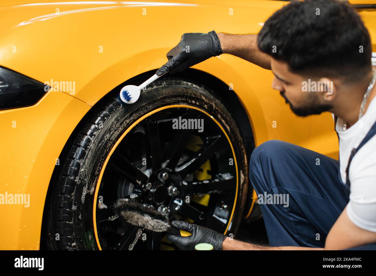 Washing car by hand, car detailing. Close up image of professional male ...