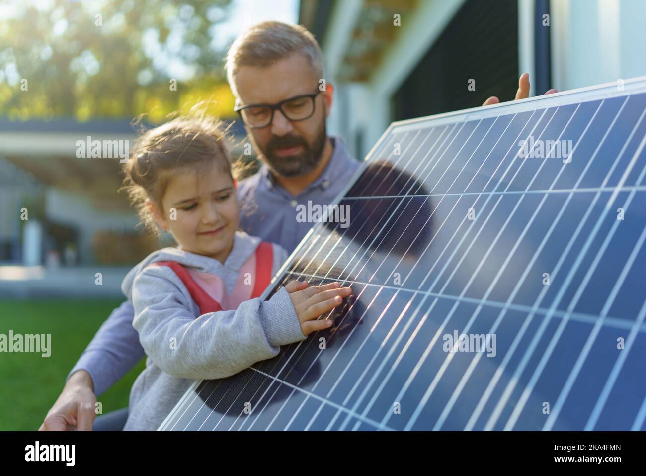 Father showing his little daughter solar photovoltaics panels ...
