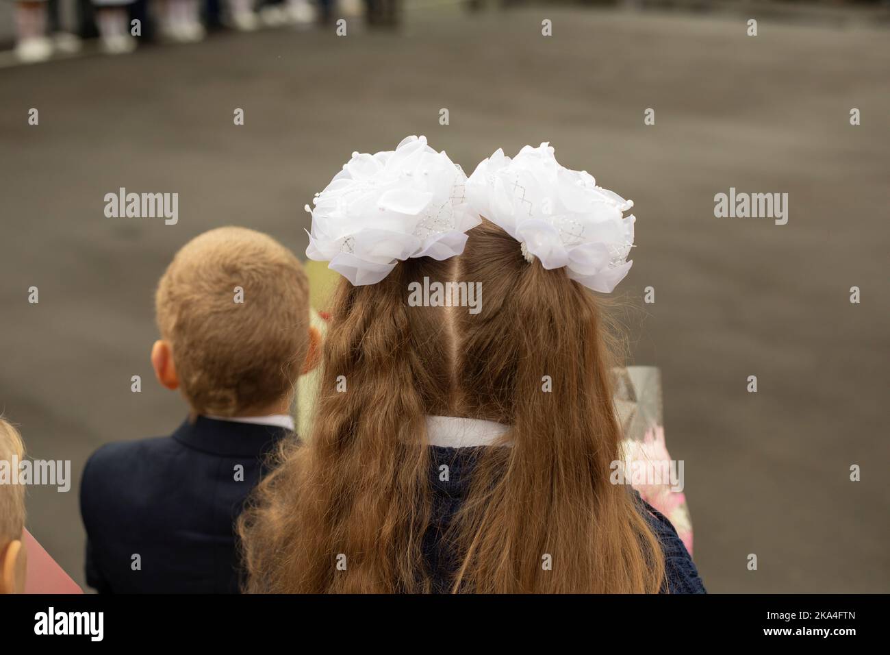 White bows from first-grader. Students on first day of school. Details ...